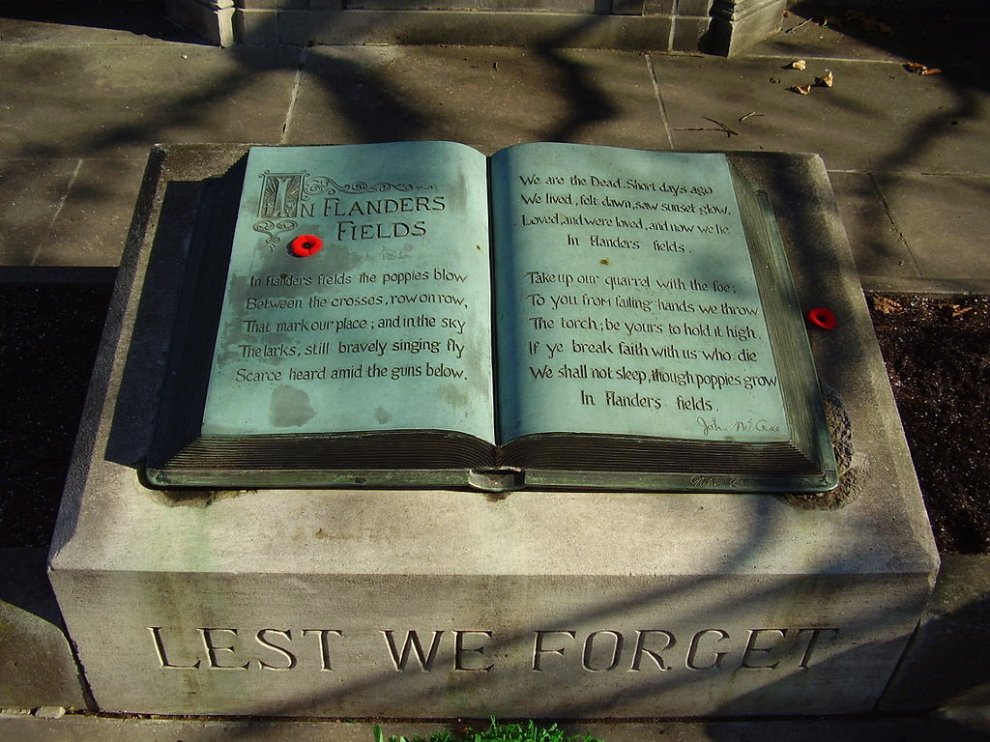 What do flowers represent when resting on the graves of the fallen?